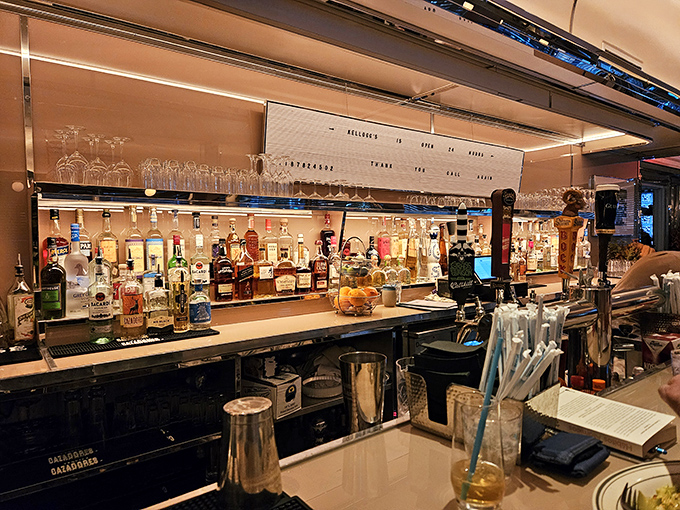 The bar at Kellogg's stands ready to serve everything from morning mimosas to midnight nightcaps. Bottles gleam like promises waiting to be kept.