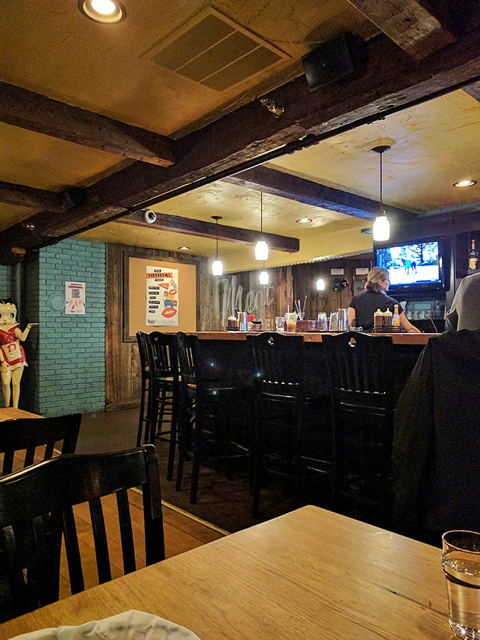The bar area combines rustic wooden beams with modern touches. A place where bourbon flows and barbecue stories grow taller with each round.