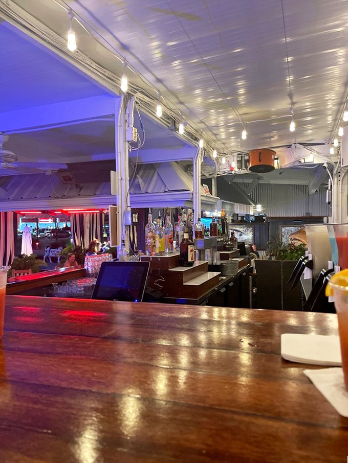 The bar glows with promise as evening falls, a beacon for thirsty sailors and landlubbers alike seeking liquid refreshment.