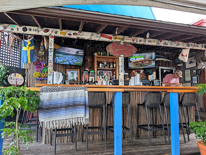 The outdoor bar area, where license plates from satisfied pilgrims create a colorful mosaic celebrating the universal language of barbecue.