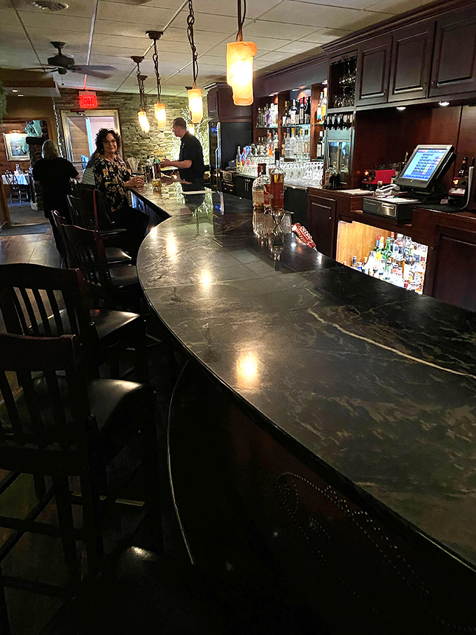 The bar's dark countertop has witnessed countless Old Fashioneds and probably absorbed some excellent stories over the years.