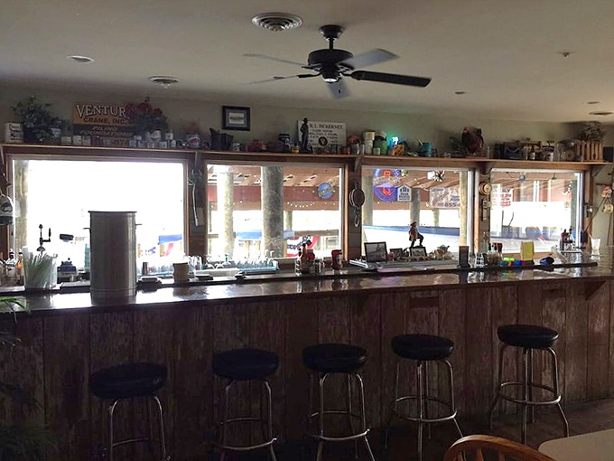 The bar at JP's&mdash;where stories flow as freely as the drinks. Maritime memorabilia lines the shelves, creating the perfect backdrop for coastal libations.