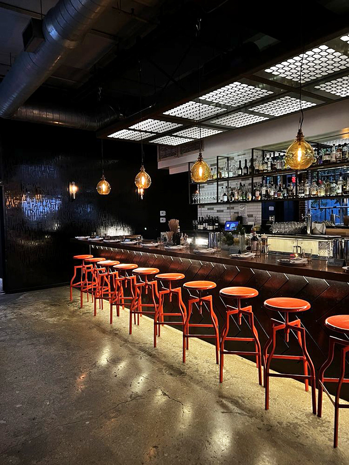 The bar at Bestia&mdash;where industrial meets intimacy. Those orange stools are like beacons calling you to sit and sip something spectacular.