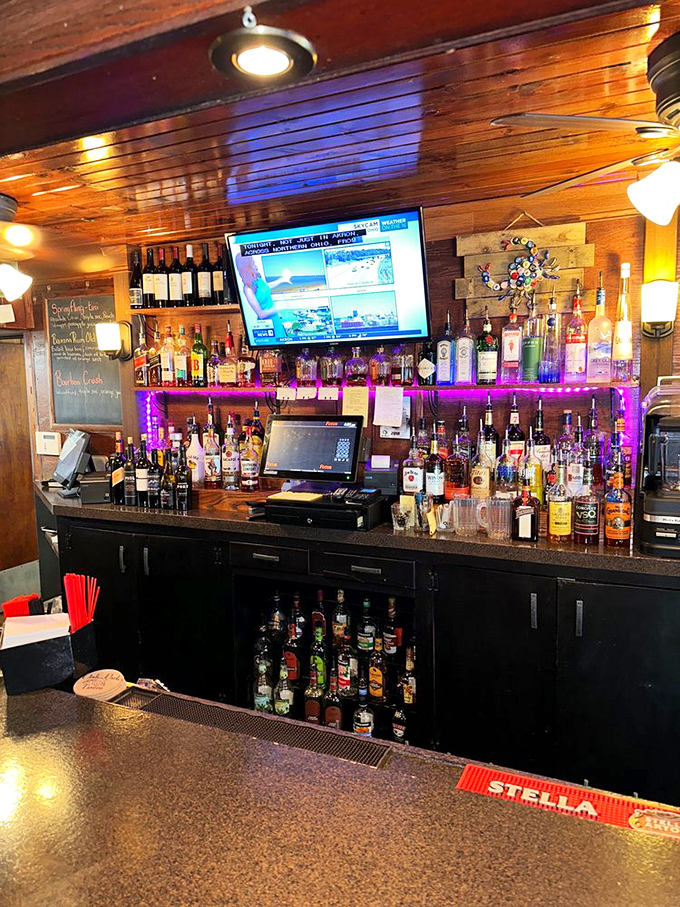 A bar stocked for serious business. No mixology theatrics needed&mdash;just honest pours and friendly conversation in warm wooden surroundings.