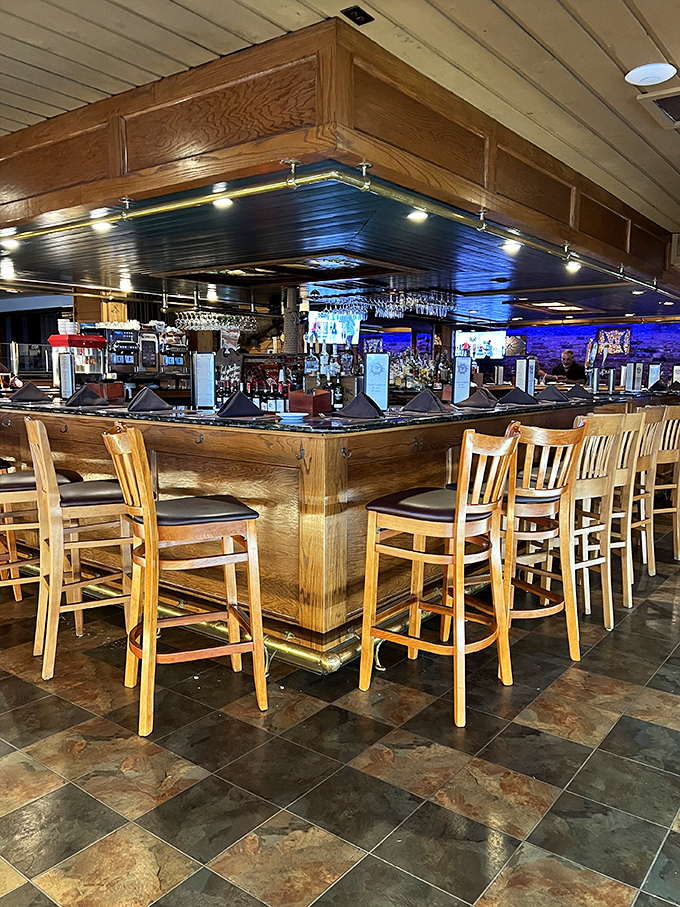 The bar area gleams with polished wood and ambient lighting&mdash;a captain's quarters where maritime tales and craft cocktails flow freely.