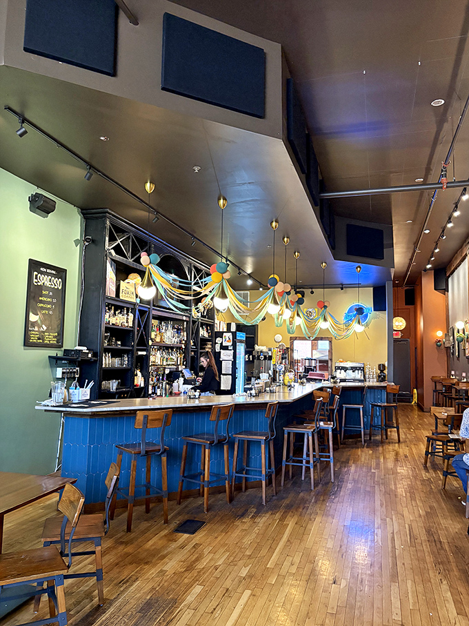 The espresso bar area features colorful decor and plenty of seating, creating a welcoming space that feels both hip and comfortably approachable.