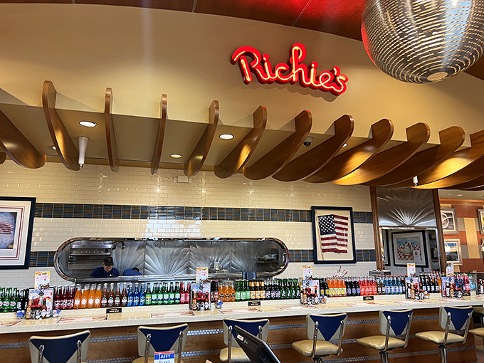 The gleaming bar area, where neon "Richie's" signage and wooden ceiling beams create a retro-cool vibe that Instagram filters try desperately to replicate.