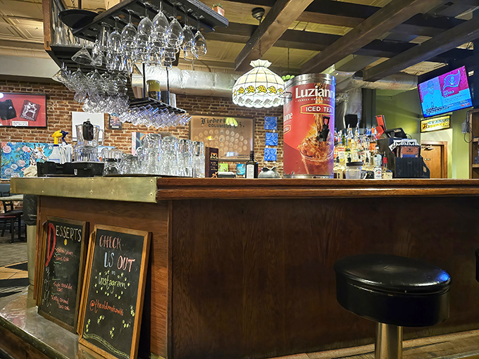 Behind the bar, where the magic happens&mdash;vintage lighting, exposed brick, and a bartender ready to pour your favorite libation.