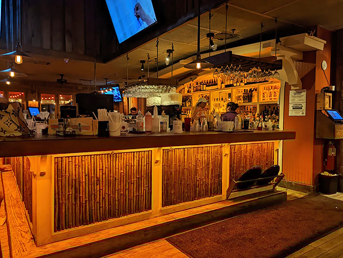 The bar at night transforms into a bamboo-clad beacon of tropical libations and seafood dreams.