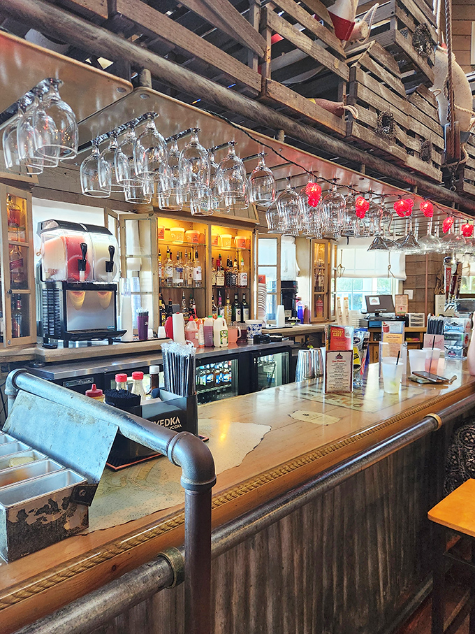 The bar area combines rustic charm with practical libation delivery. Those hanging glasses are just waiting to be filled with something refreshing.