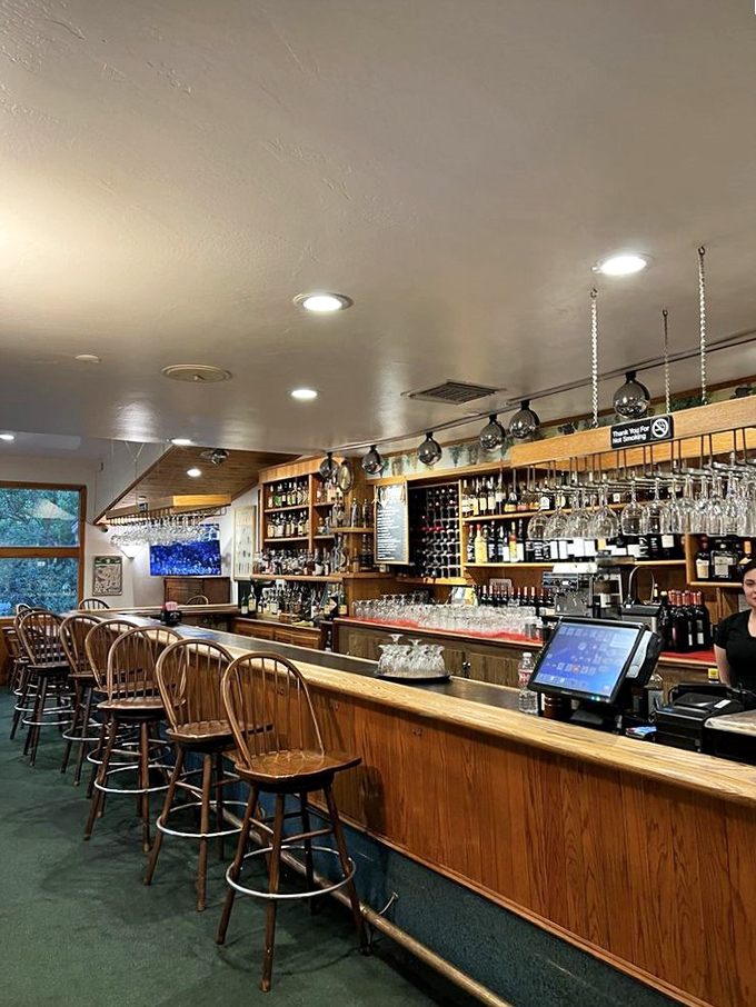 The bar area doesn't just serve drinks&mdash;it crafts liquid companions for your culinary journey through France, no passport required.