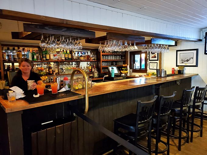 The bar isn't just serving drinks; it's serving stories. Wood-topped and welcoming, it's where locals and visitors alike toast to another perfect day.