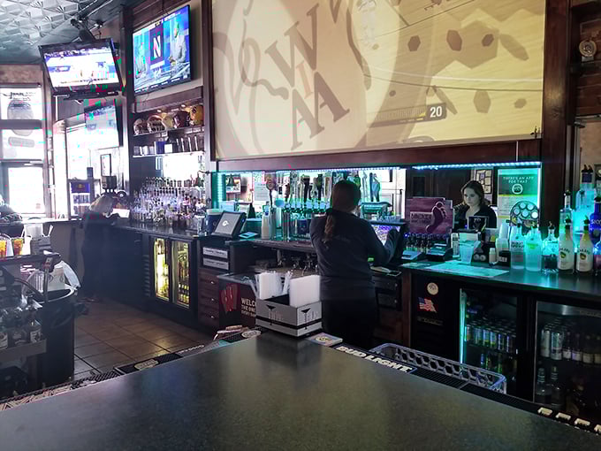 The bar stretches like a runway of possibilities, with taps standing at attention and bottles gleaming under lights that say "your next favorite drink is here."
