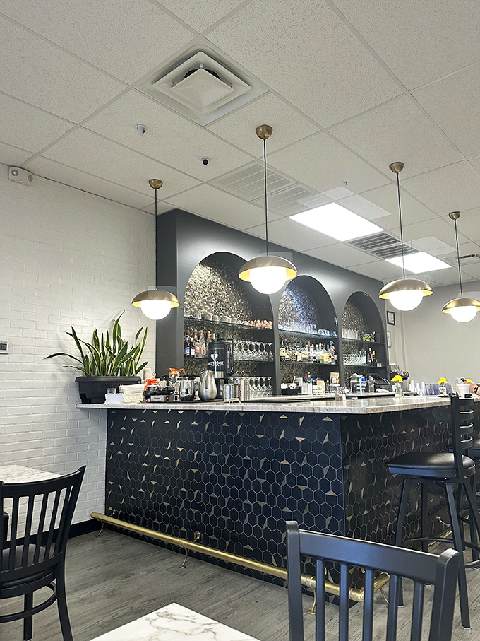 The bar area's hexagonal tile and elegant arches create a space that says "yes, breakfast deserves a backdrop this beautiful."