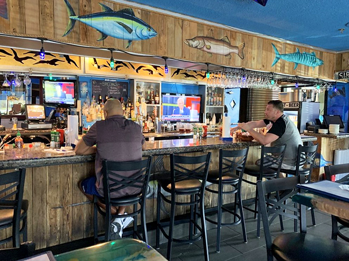 The rustic bar area, with mounted fish watching from wooden walls, feels like the captain's quarters of a particularly successful fishing vessel.