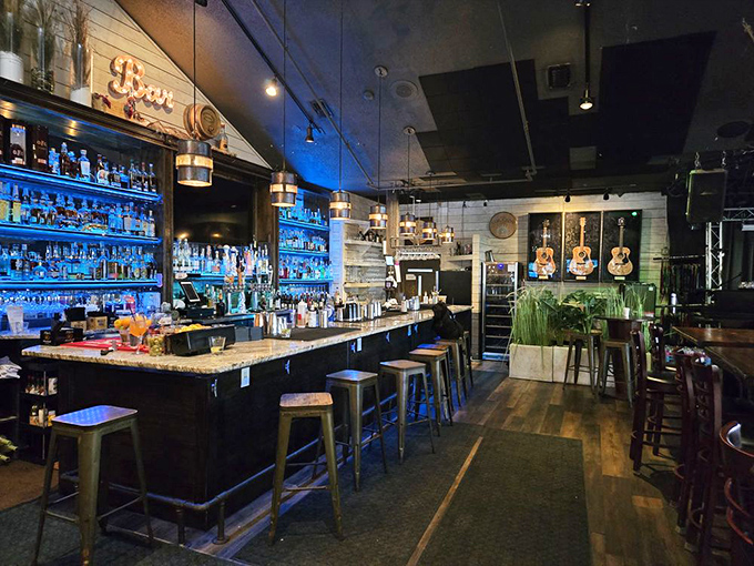 Blue lighting transforms this bar into an underwater fantasy. The bottles glow like treasures in a shipwreck, promising libations worthy of Neptune himself.