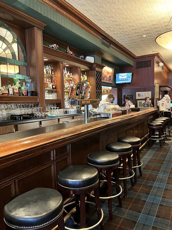 The bar's polished wood gleams like a beacon for the thirsty, while those stools have supported generations of Minnesotans sharing stories and Manhattan cocktails.