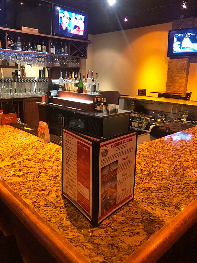 The bar area gleams with promise, its granite countertop reflecting possibilities. Even the TVs know they're secondary to what happens on your plate.