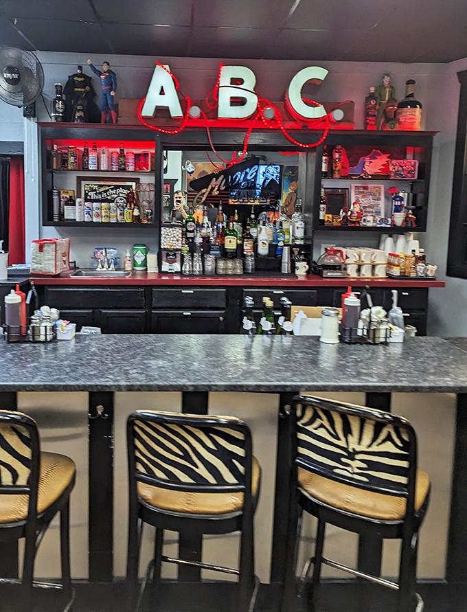 The bar area features playful ABC signage and collectibles, proving this spot has personality to spare beyond the food.