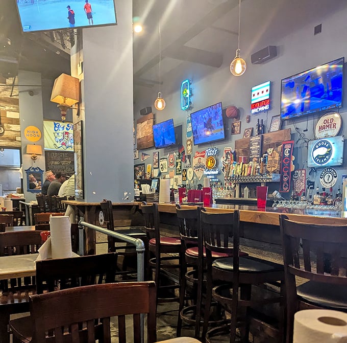 The bar area glows with neon signs and sports memorabilia, creating a shrine to the twin pleasures of good food and game day.
