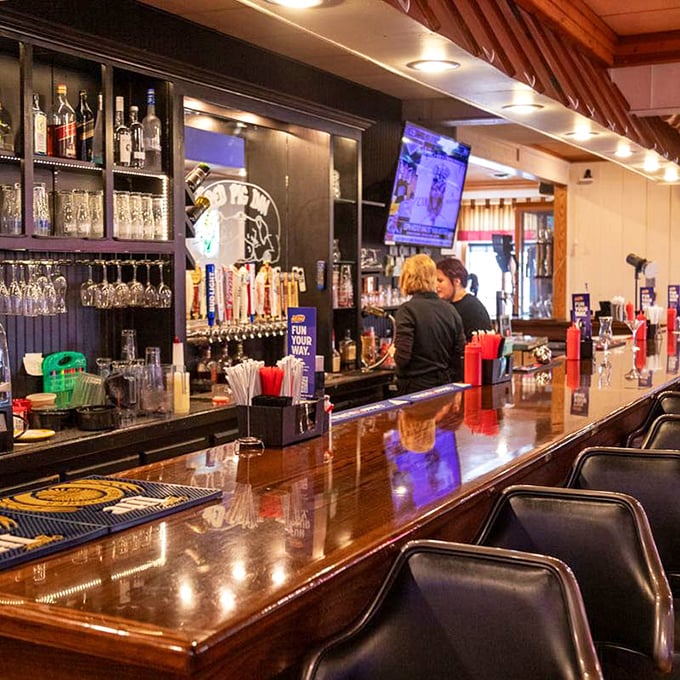 The bar beckons with gleaming taps and promises of cold beverages to accompany your warm, smoky feast.