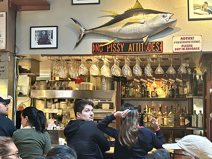 The mounted tuna watches over diners like Neptune's guardian. That "No Pissy Attitudes" sign is the restaurant's only strict rule.