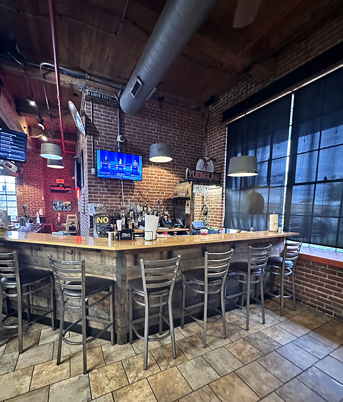 The rustic bar area offers a front-row seat to BBQ paradise. Those brick walls have absorbed decades of satisfied sighs and barbecue dreams.