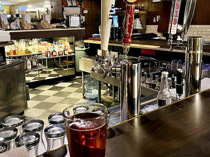 The bar area invites you to pull up a stool and settle in. Notice the classic checkered floor&mdash;no design consultant needed, just timeless appeal.