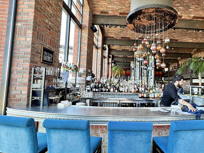 A bar that says "pull up a chair and stay awhile," where hanging ornaments catch the light like bubbles in champagne.