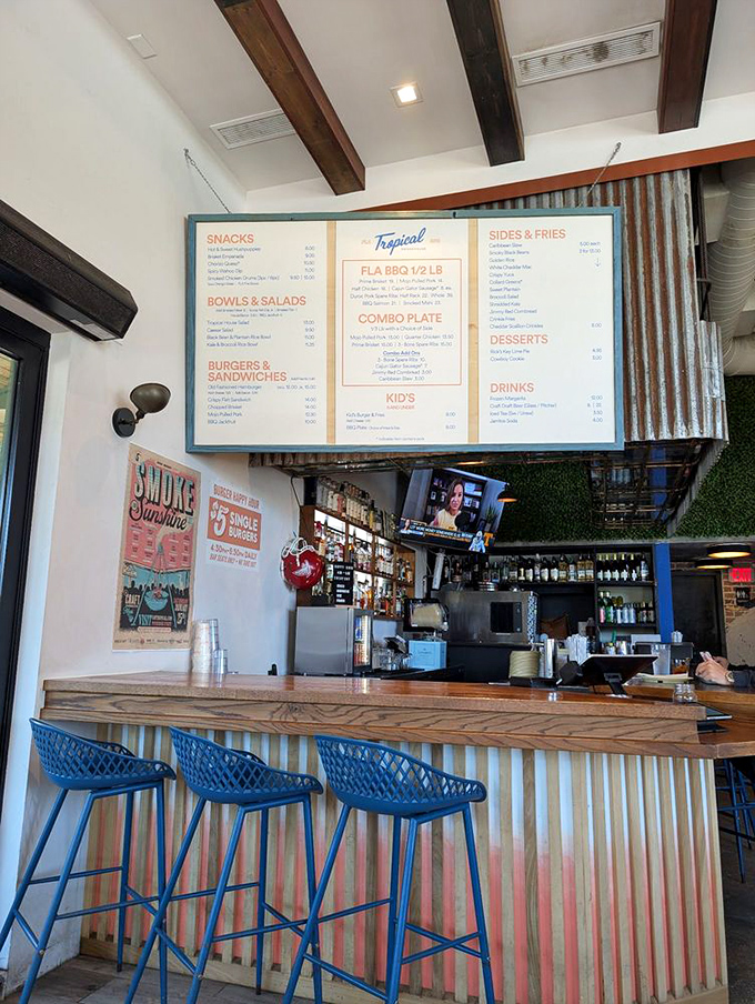 The bar counter invites you to pull up a blue stool and settle in for some serious Florida BBQ exploration.