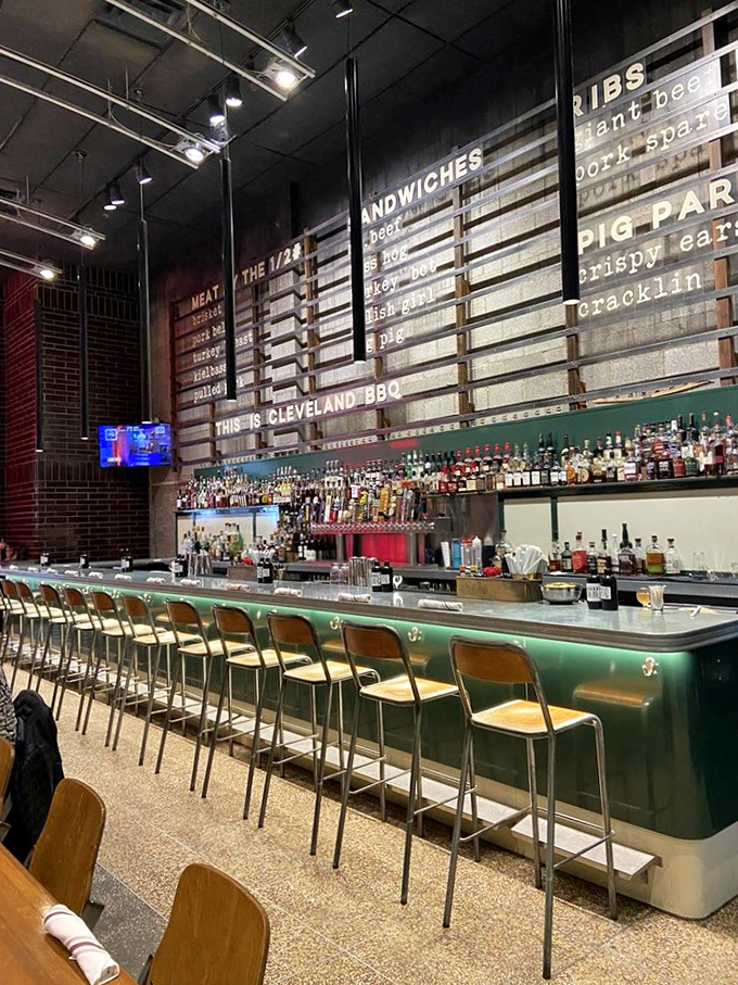 This bar stretches out like a bourbon boulevard, where every bottle has a story and every seat has a view.