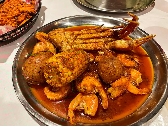 A metal bowl brimming with seafood and spice&mdash;where crab legs stretch out like they're lounging at a five-star resort in butter sauce.