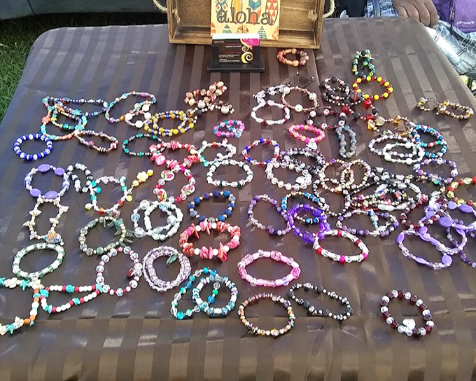 Colorful beaded bracelets spread across the table like a rainbow you can wear, each one handcrafted with personality to spare.