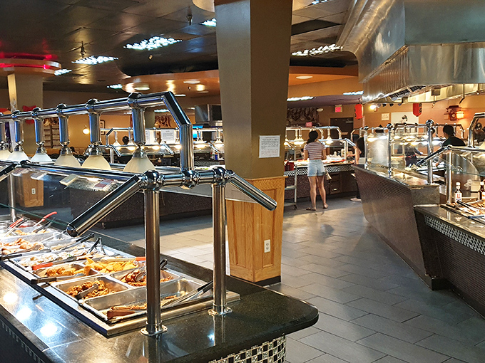 The buffet stations stretch out like a delicious highway where every exit leads to flavor town.