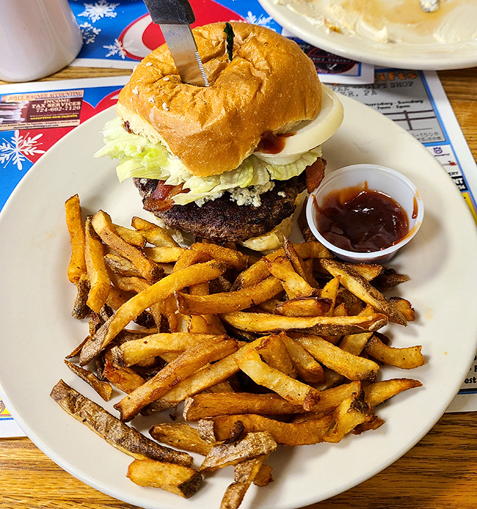 Classic diner counter seating where regulars perch on chrome stools, trading local news while waiting for plates of comfort food excellence.