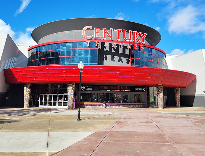 Century Theatres' bold red facade promises cinematic escapes when your shopping bags get too heavy or your feet need a break.
