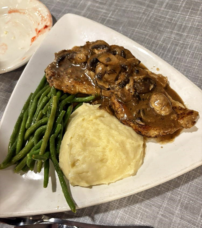 Chicken Marsala swimming in mushroom-studded sauce—proof that even at a seafood restaurant, the land offerings deserve standing ovations.