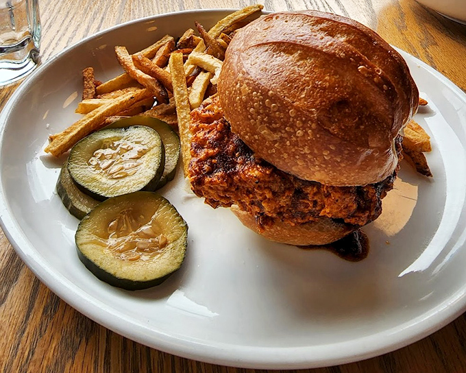 This isn't your average chicken sandwich&mdash;it's a towering achievement of crispy, juicy perfection nestled in a golden bun with house pickles.