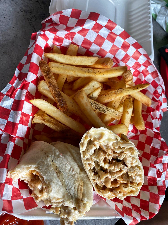 A cheesesteak with fries isn't just a meal&mdash;it's a Pennsylvania tradition served on classic red and white checkered paper.