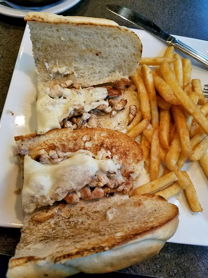 A chicken cheesesteak sandwich that might make Philly jealous. The melted cheese is performing magic tricks between those toasted slices.