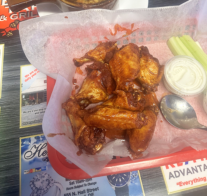 These wings aren't just cooked &ndash; they're coaxed to perfection, glistening with sauce that promises to leave evidence of your indulgence on at least three napkins.