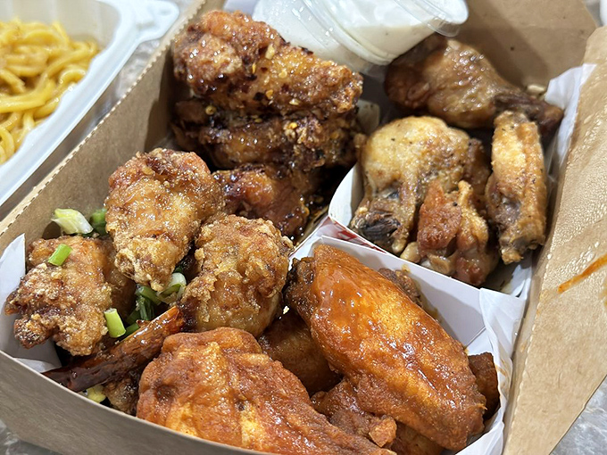 Crispy, golden chicken wings nestled in their takeout container &ndash; because sometimes even seafood lovers need a brief detour into poultry paradise.