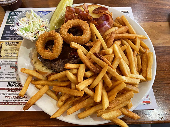 This burger doesn't just come with onion rings&mdash;it wears them like jewelry. The kind of magnificent excess that makes diners America's culinary happy place.