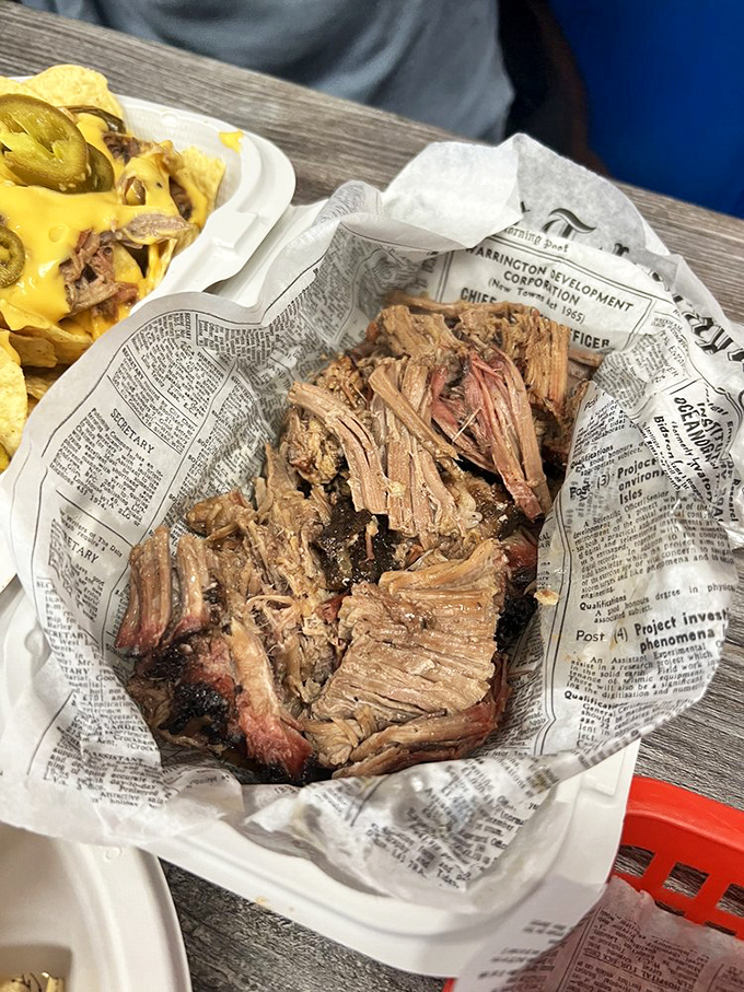 Chopped brisket wrapped in newspaper like precious cargo - which, let's be honest, it absolutely is.