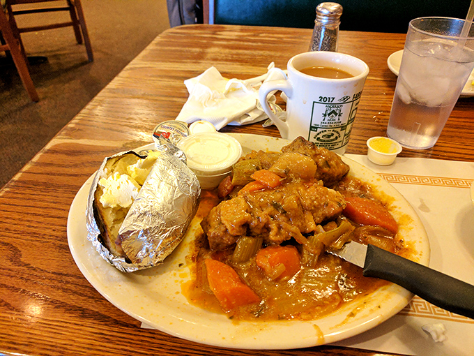 City chicken swimming in gravy alongside a baked potato in foil&mdash;comfort food that wraps around you like your favorite sweater.