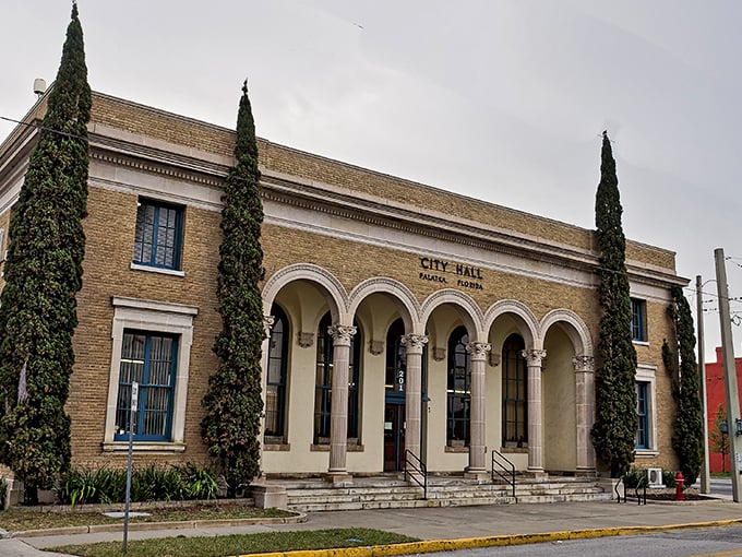 Palatka's City Hall exudes Mediterranean elegance with its arched entryway and cypress sentinels &ndash; civic pride wrapped in architectural distinction.
