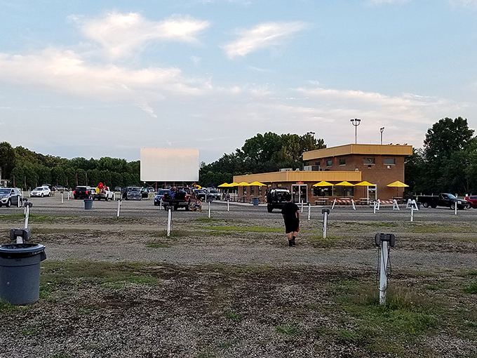 Yellow umbrellas dot the concession area as early arrivals secure their spots. The calm before the cinematic storm.