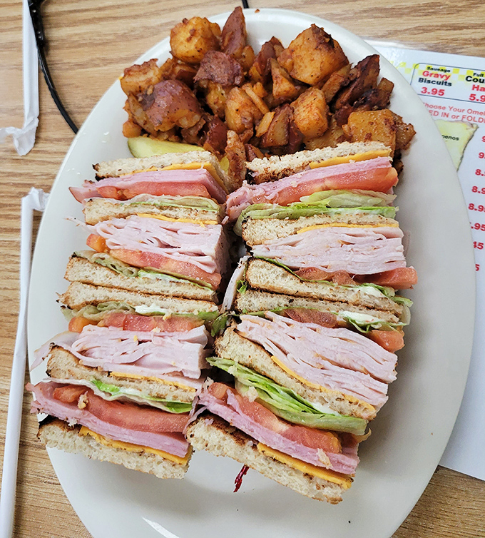 This club sandwich isn't playing around—it's stacked higher than your weekend to-do list and twice as satisfying to finish.