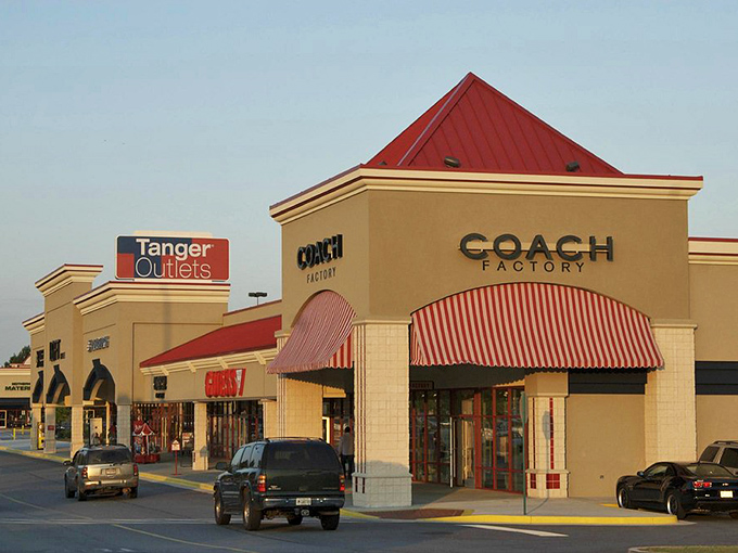 The iconic red-roofed Coach store, where leather dreams come true. Like a beacon of luxury, it calls to handbag enthusiasts from miles around.