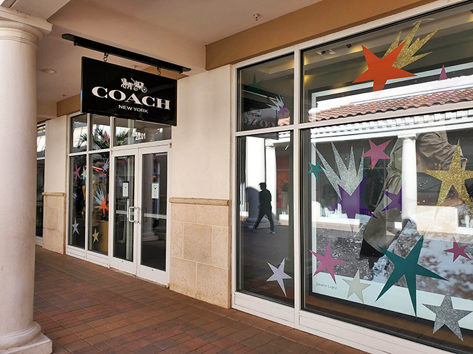 Coach's gleaming storefront promises leather goods that will outlast trends and possibly your mortgage.